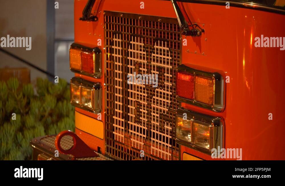 Fire engine truck emergency warning lights and light bar at night in a ...