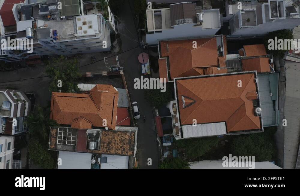 looking directly down over narrow street and tilting the camera up to ...
