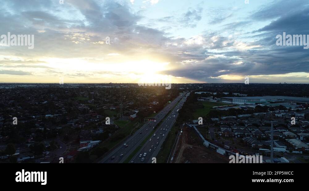 Suburban sunset or sunrise featuring a freeway running below Stock ...