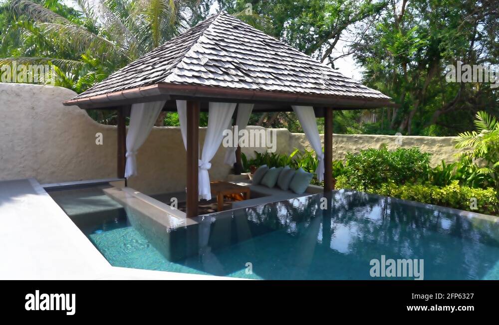Luxurious poolside cabana beside a private infinity pool at a tropical ...