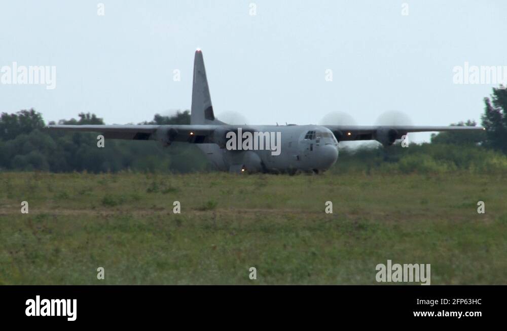 Lockheed C-130 Hercules, military transport aircraft taxis on runway ...