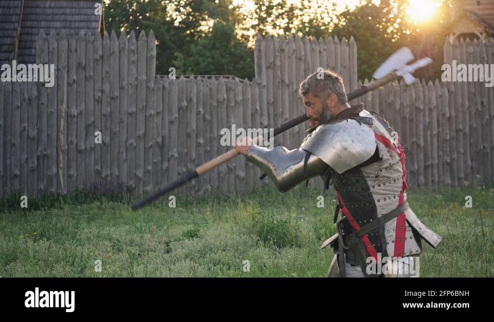 Knight practicing using the war hammer for battle during sunset Stock ...