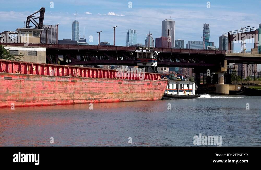 tug boat pushing barge under bridge city skyline 4k Stock Video Footage ...