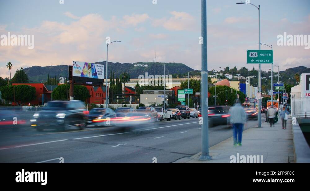 Time-lapse of traffic intersection and Hollywood signin Los Angeles ...