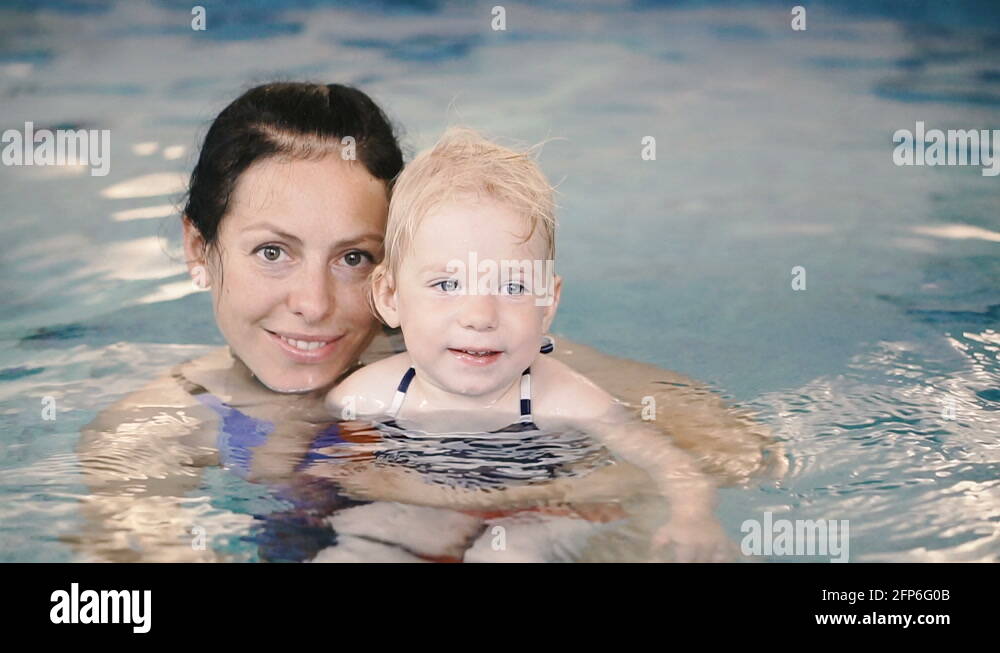 Swimming pool. Mom teaches a young child to swim in the pool Stock ...
