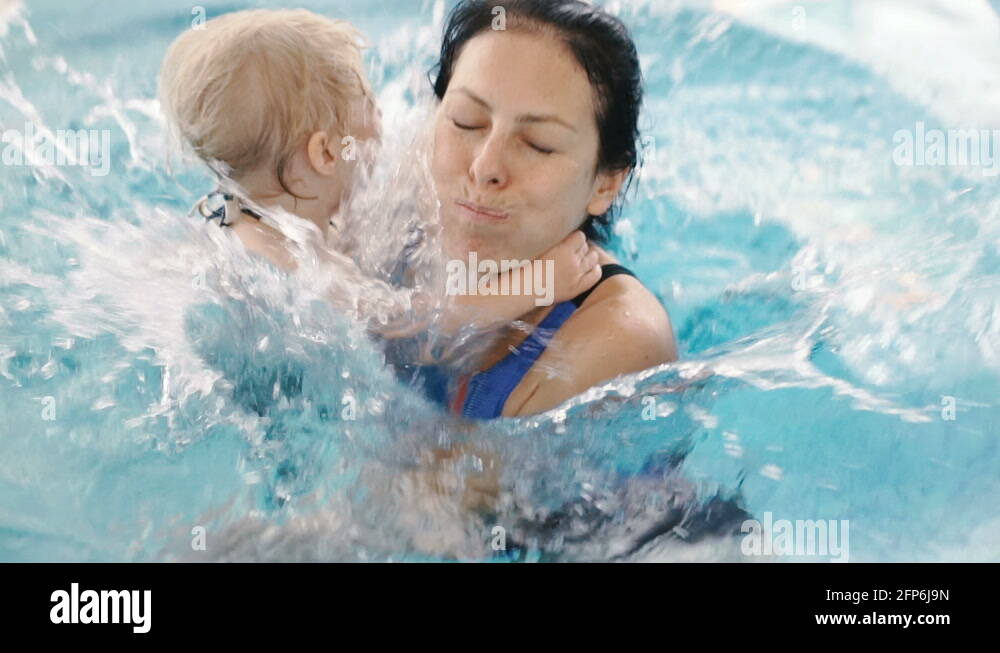 Swimming pool. Mom teaches a young child to swim in the pool Stock ...
