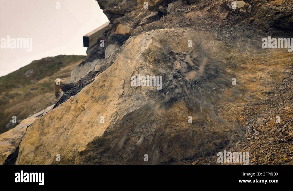 Slowmo, A piece of shale rock smashes against a boulder turns into ...