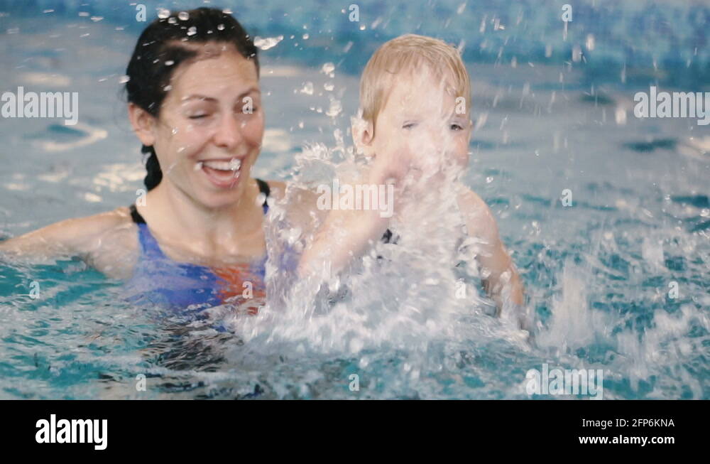 Swimming pool. Mom teaches a young child to swim in the pool Stock ...