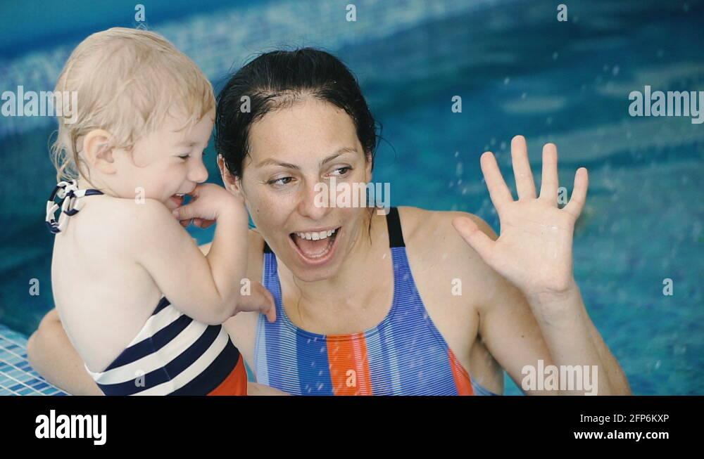 Swimming pool. Mom teaches a young child to swim in the pool Stock ...