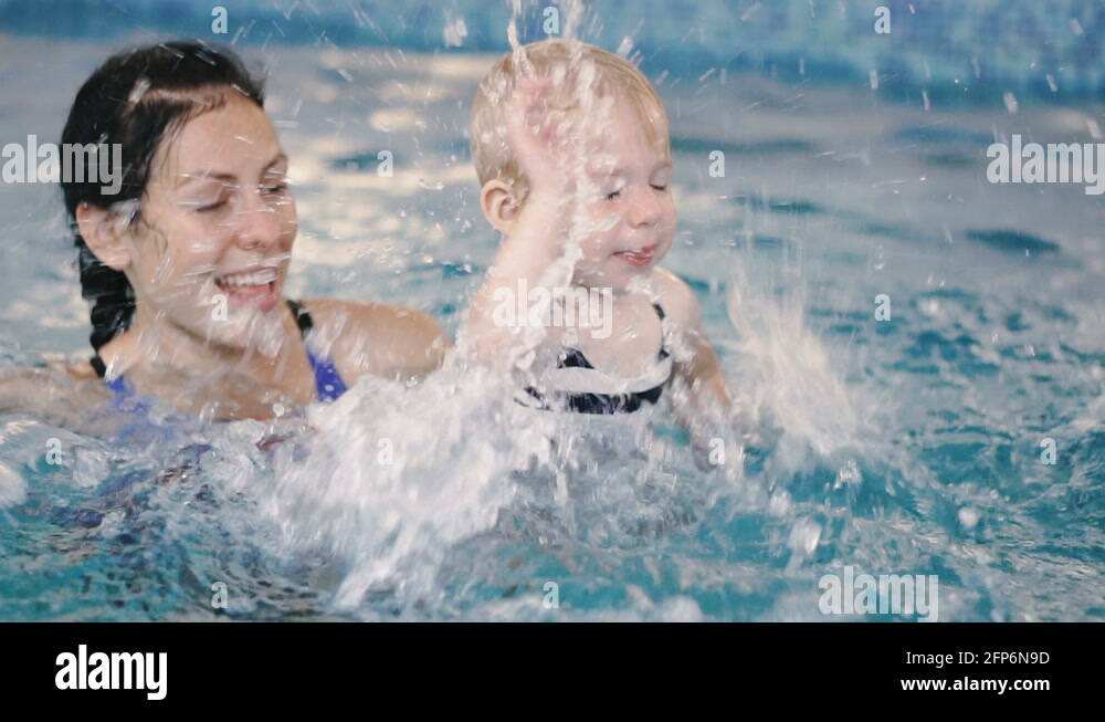 Swimming pool. Mom teaches a young child to swim in the pool Stock ...