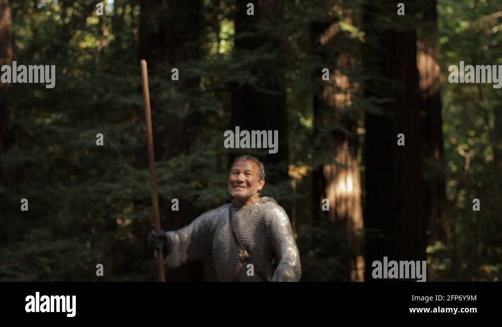 Medieval knight throws his spear, draws his sword, and yells Stock ...