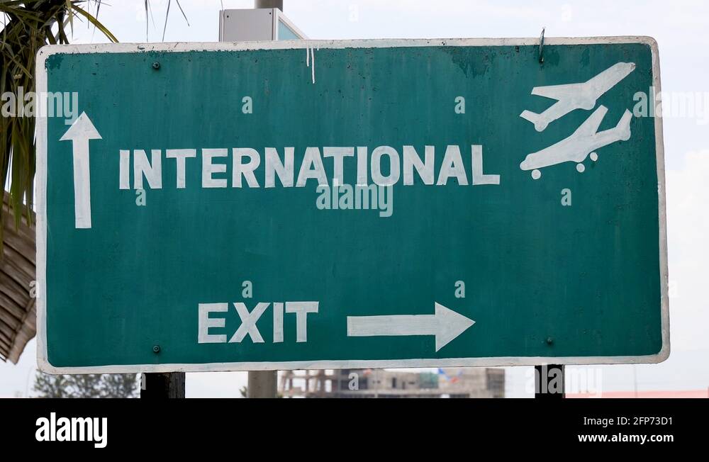 Sign board with International landing and takeoff written at an airport ...