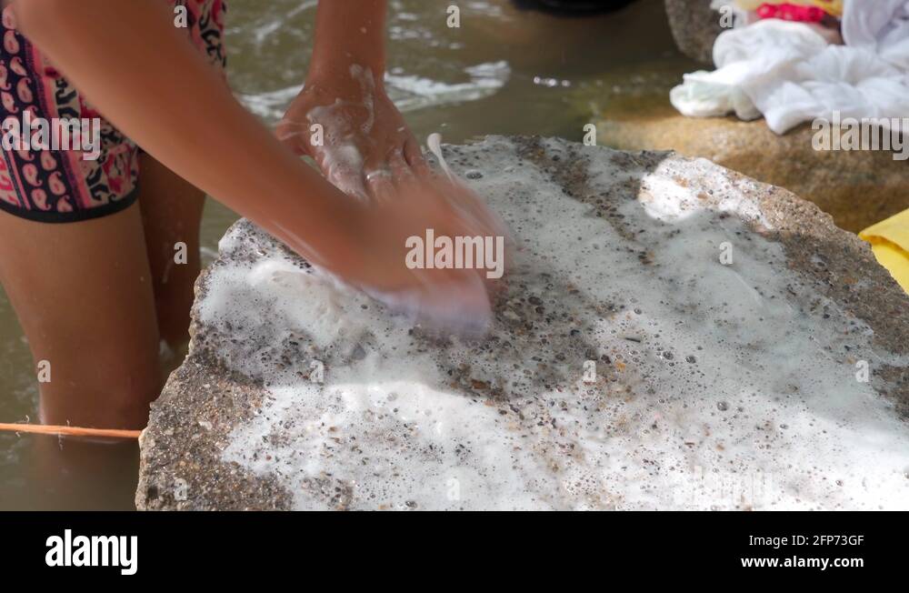 Wash clothes on rock Stock Videos & Footage - HD and 4K Video Clips - Alamy