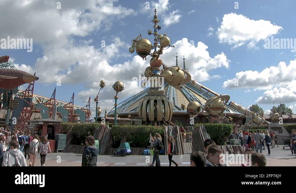 Disneyland Paris Park Orbitron ride medium shot with people walking on ...