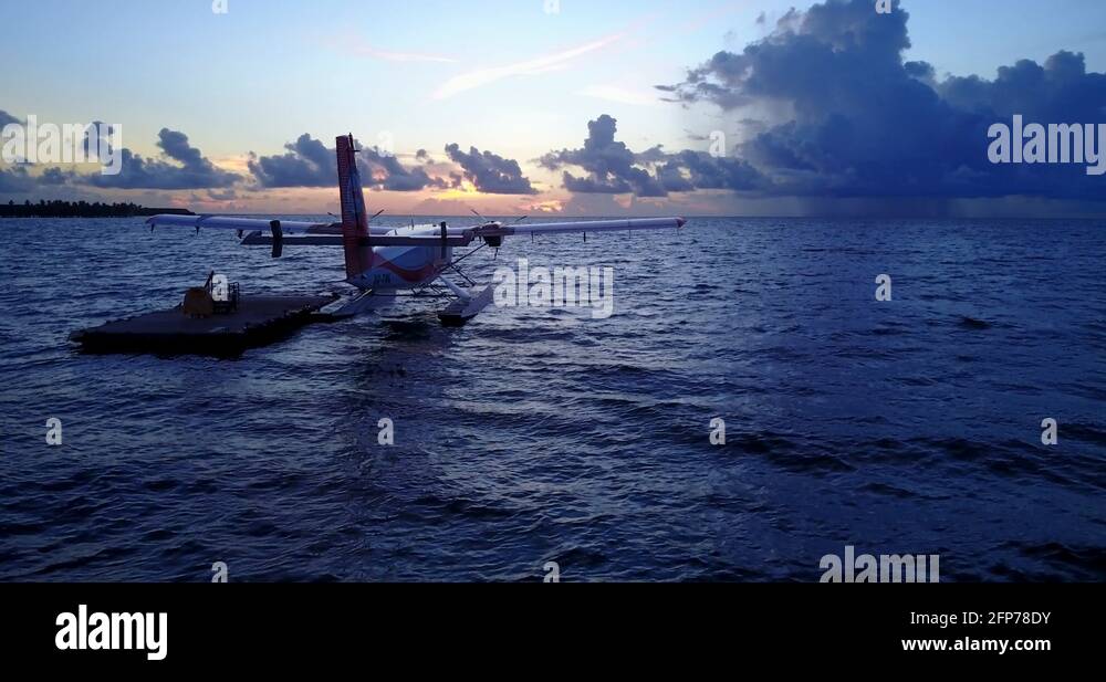 Drone close up footage of a seaplane anchored next to a floating ...