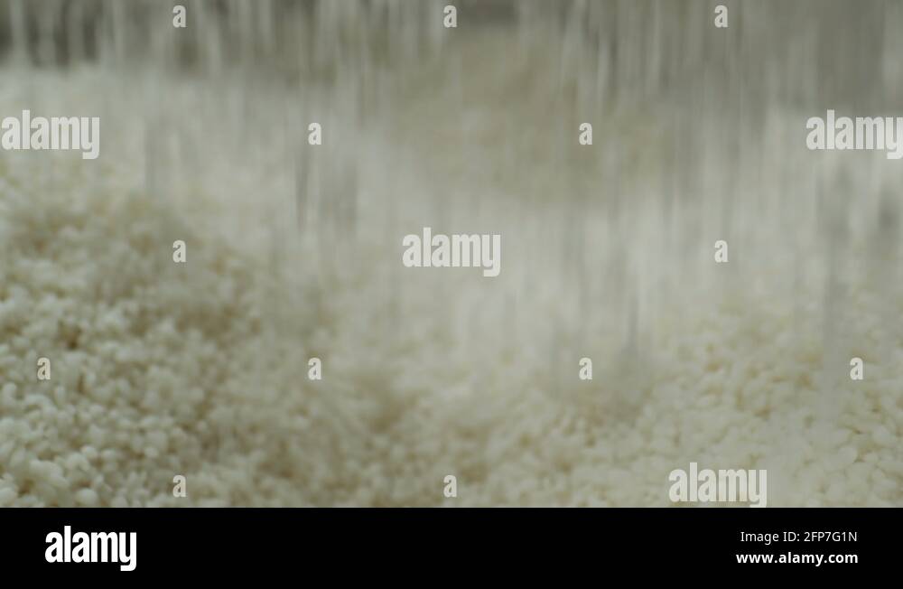 Rice falling in slow-motion to pile Stock Video Footage - Alamy