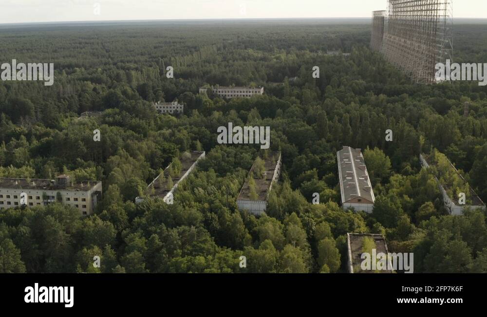 Rising aerial orbit around Duga Radar and abandoned buildings in ...