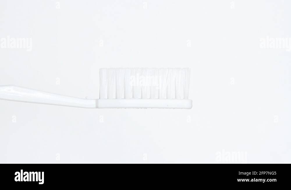 Putting toothpaste on a brush on white background Stock Video Footage ...