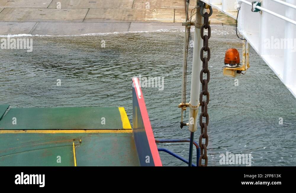 Rear view of ferry docking from ocean to land at harbour, static Stock ...