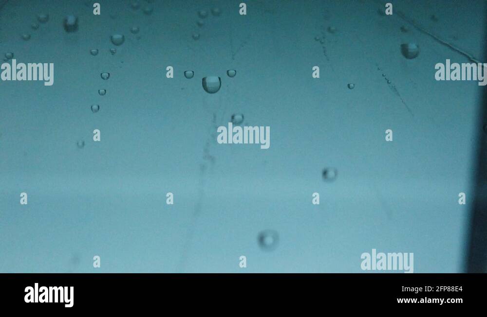 The rain drops falling on the windows very slowly, refreshing and ...