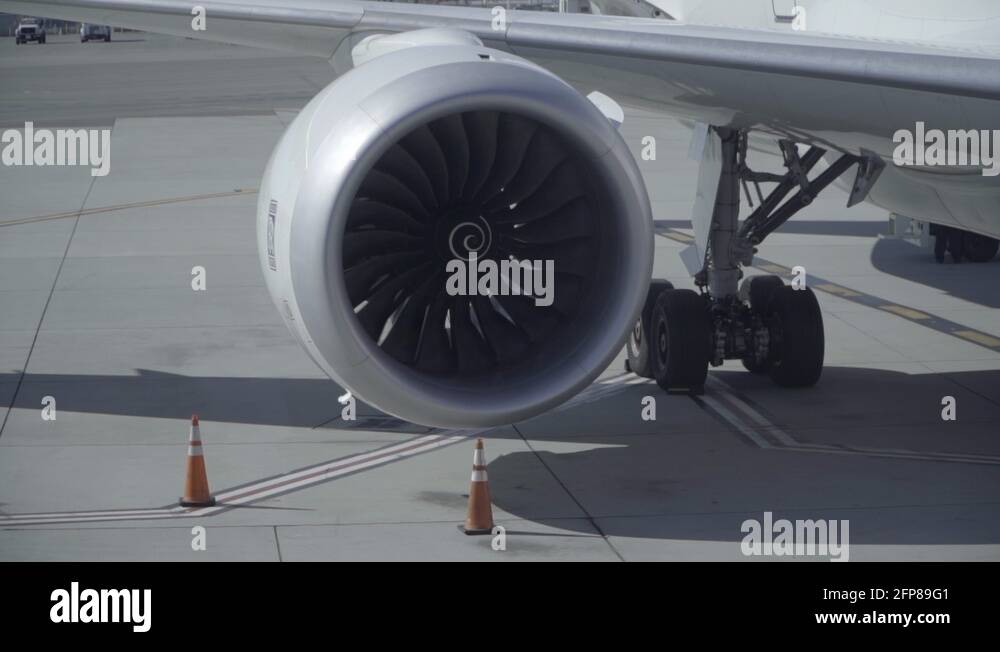 Close Up of Airplane Jet Turbine Spinning While Plane is Parked at ...