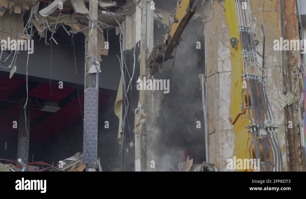 Destruction of the cinema building on a steel frame with a machine with ...