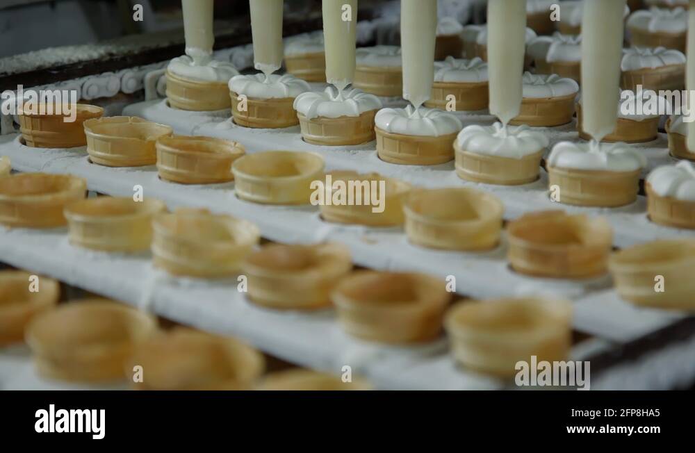 Ice Cream Production Line. Filling of Wafer Cups with Ice Cream in Ice ...