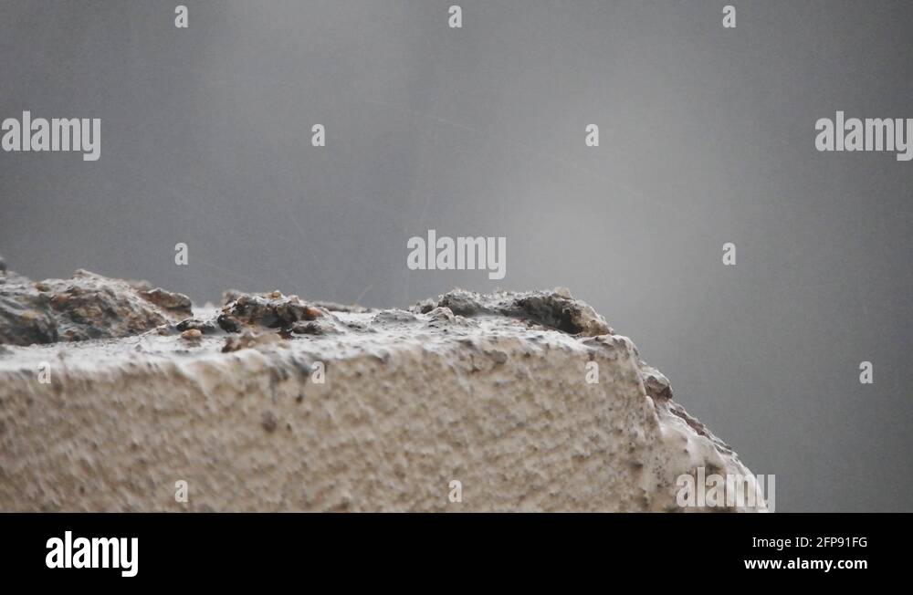 Rain drops and hailstones falling and dripping on plaster and building ...