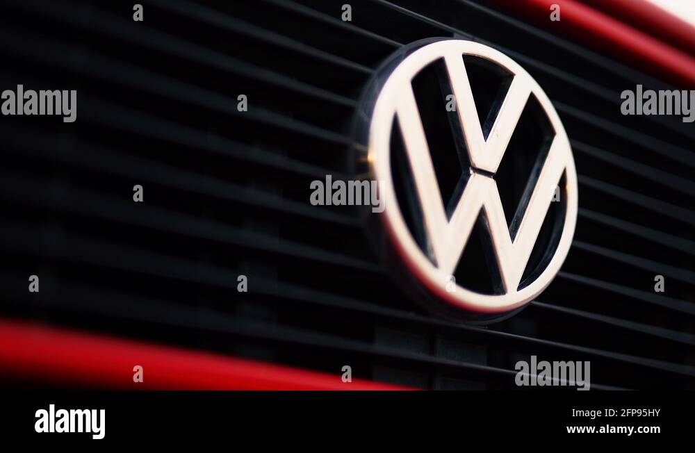 Volkswagen logo on black grille of red modified VW Golf MK1, close up ...