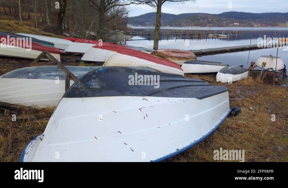 Upside Down row boats on the side of the lake keep them clear of rain ...