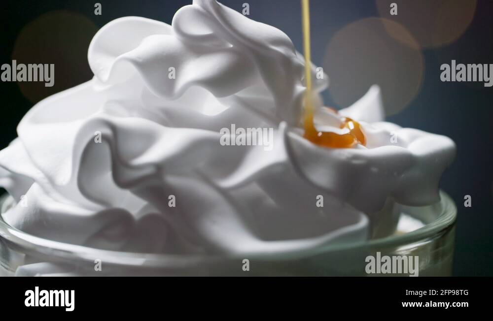 caramel sirup poured dripping over ice cream milkshake whipped cream ...