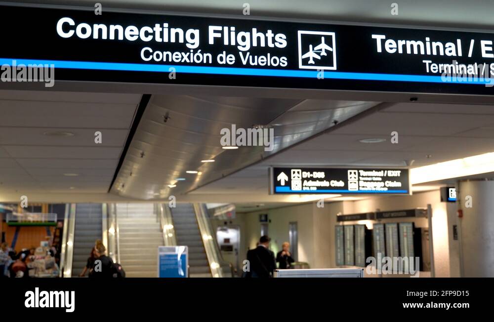 Trucking shot to right of airport signage for terminal exit and ...