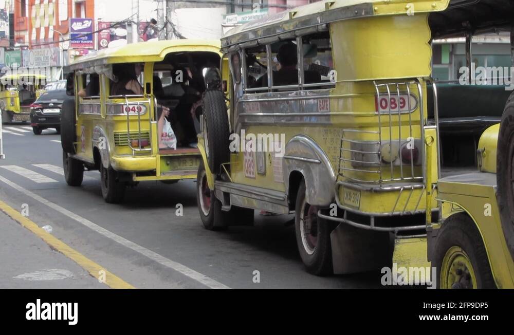Iconic jeepney of the Filipino waiting for passenger in the busy street ...
