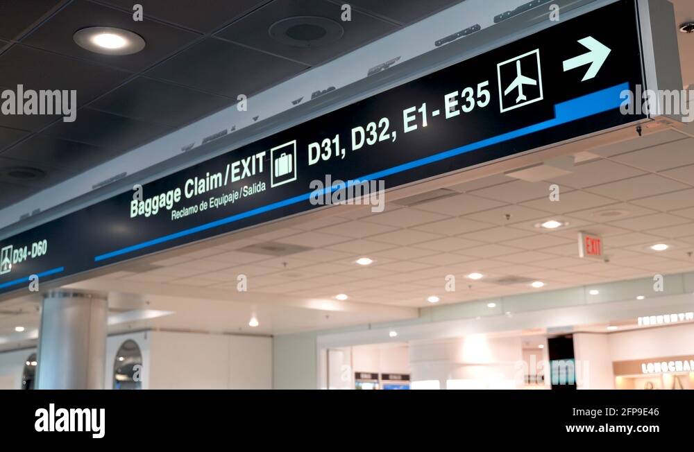 Baggage claim sign giving direction at airport Stock Video Footage - Alamy