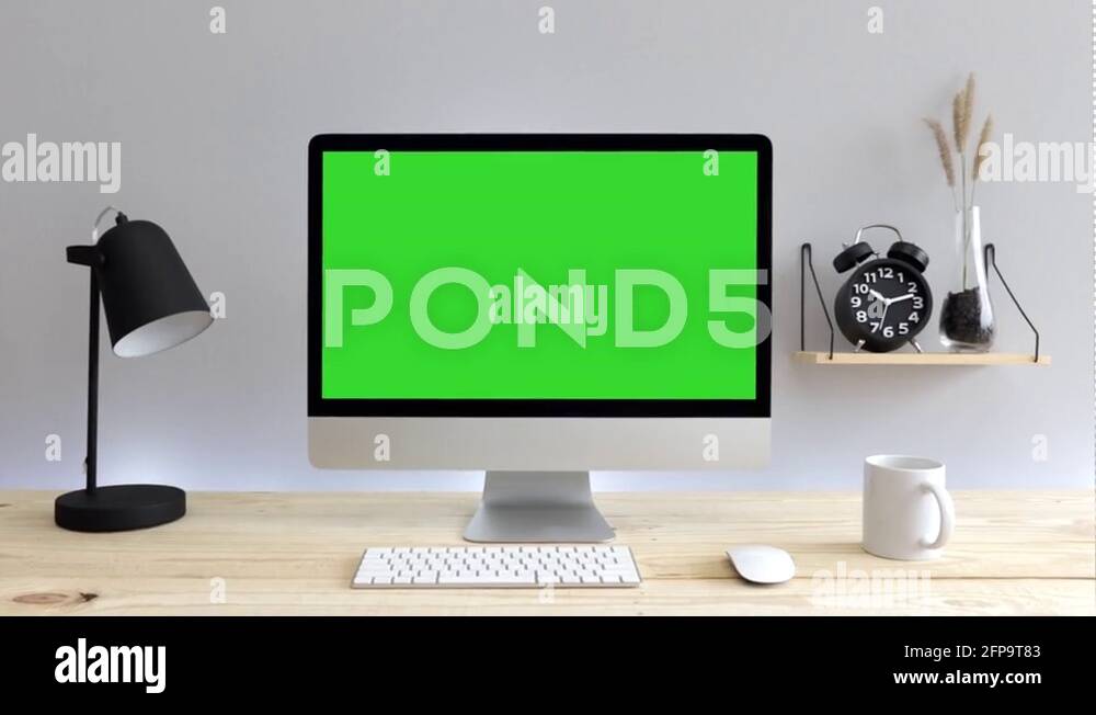 Computer desktop with mock-up green screen on wood table with grey ...