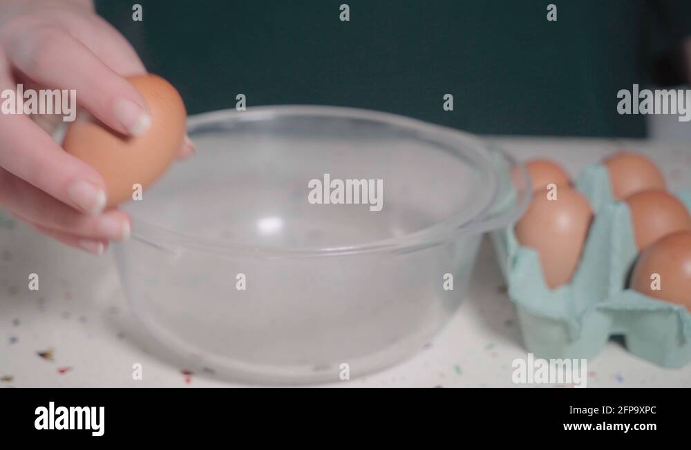 Woman Cracking Egg with One Hand on Side of Glass Bowl, Closeup Stock ...