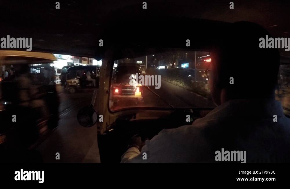 travelling in back of auto rickshaw navigating through busy street ...