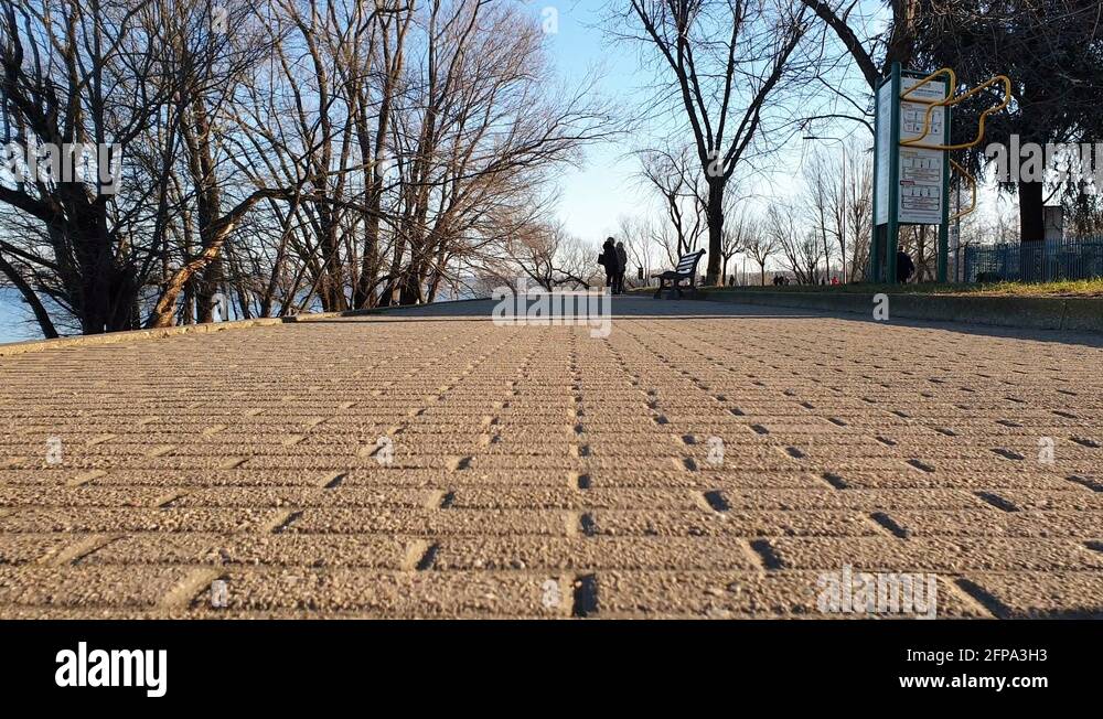 Low angle perspective of tracking people walking on pedestrian street ...