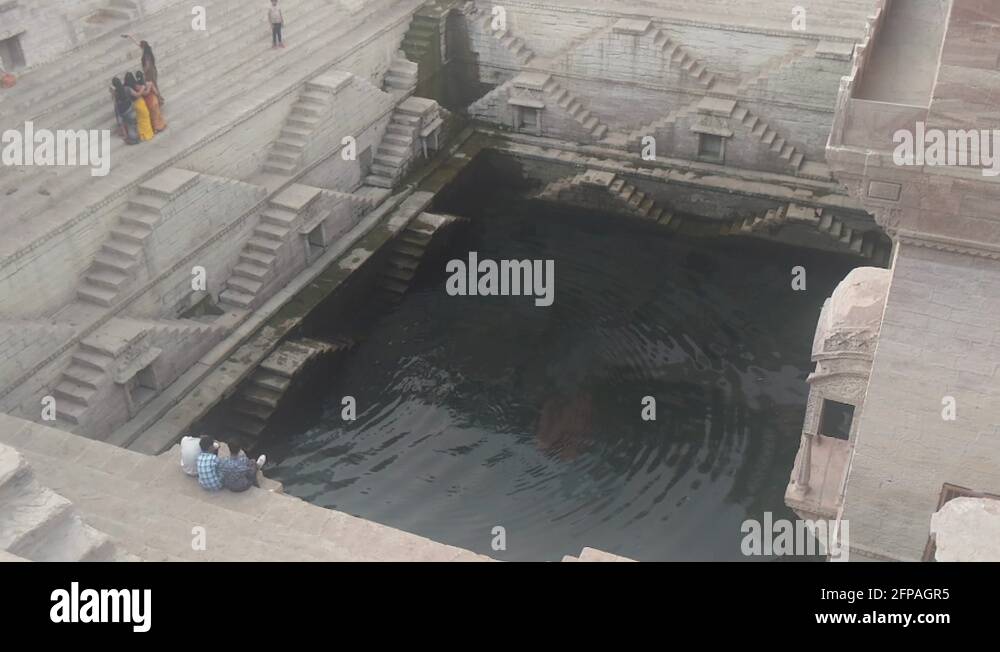 A swimmer surfaces from the depths of a beautiful step well in Jodhpur ...