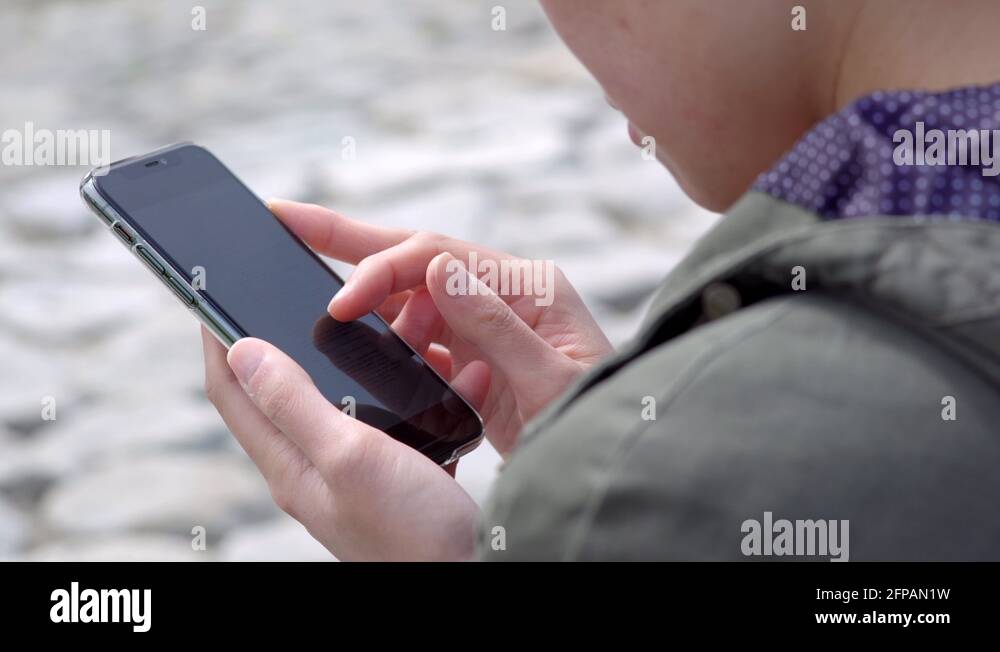 Woman's Hand Holding And Scrolling The Screen Of Her Smartphone ...