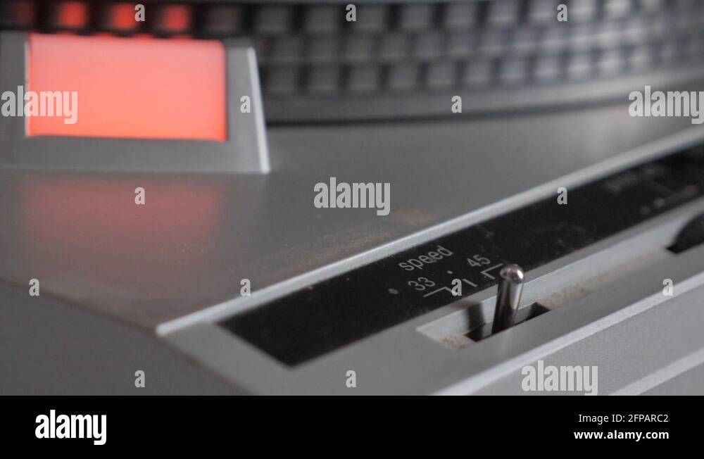 Hand changing speed switch of vinyl record spinning on antique ...
