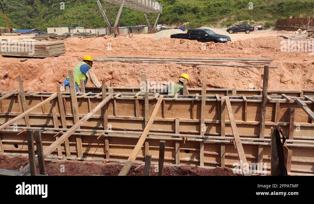 Construction workers installing & fabricating timber form work at the ...