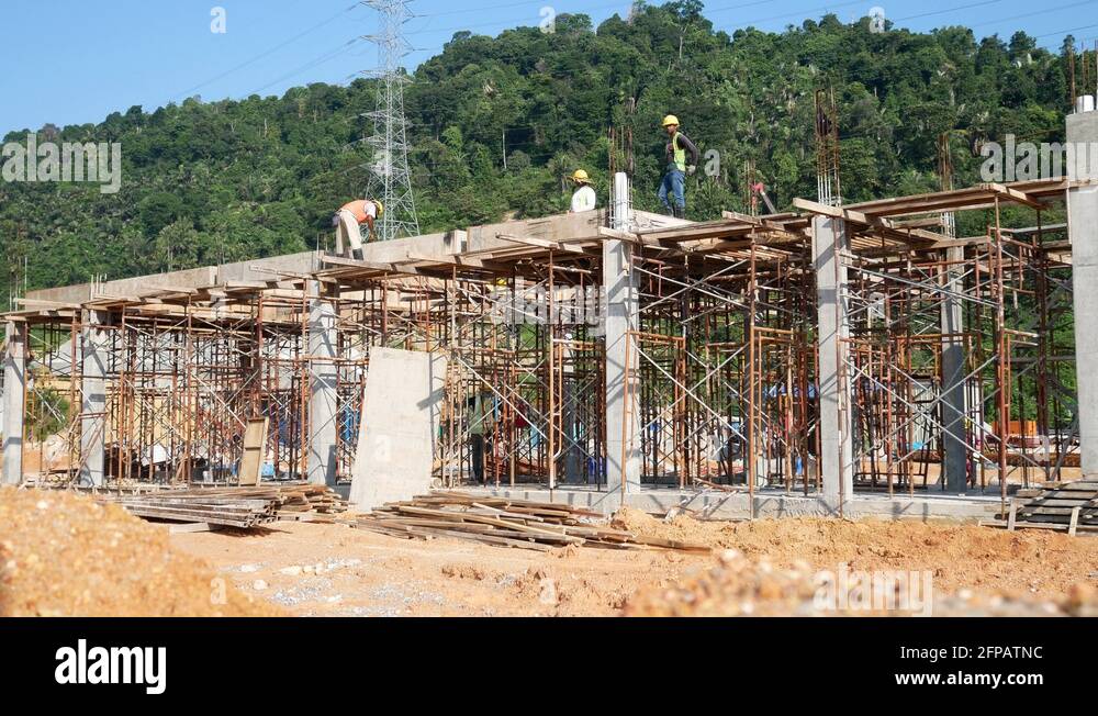 Construction workers installing & fabricating timber form work at the ...