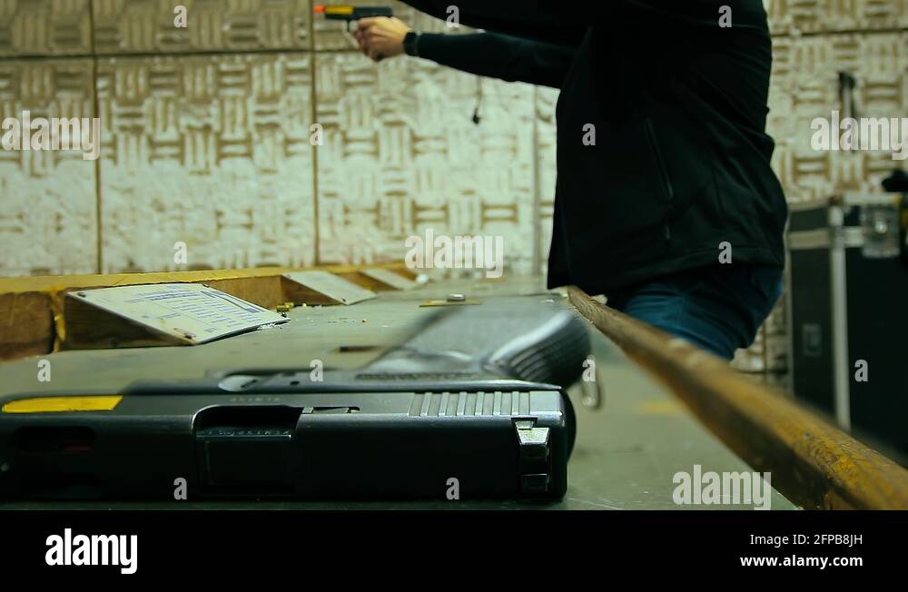 Cinemagraph of two unrecognizable men shoot with 9mm pistol in shooting ...