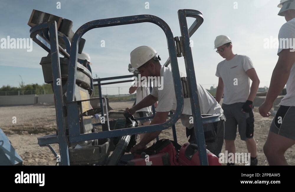 Construction workers on construction site loading their tools and Stock ...