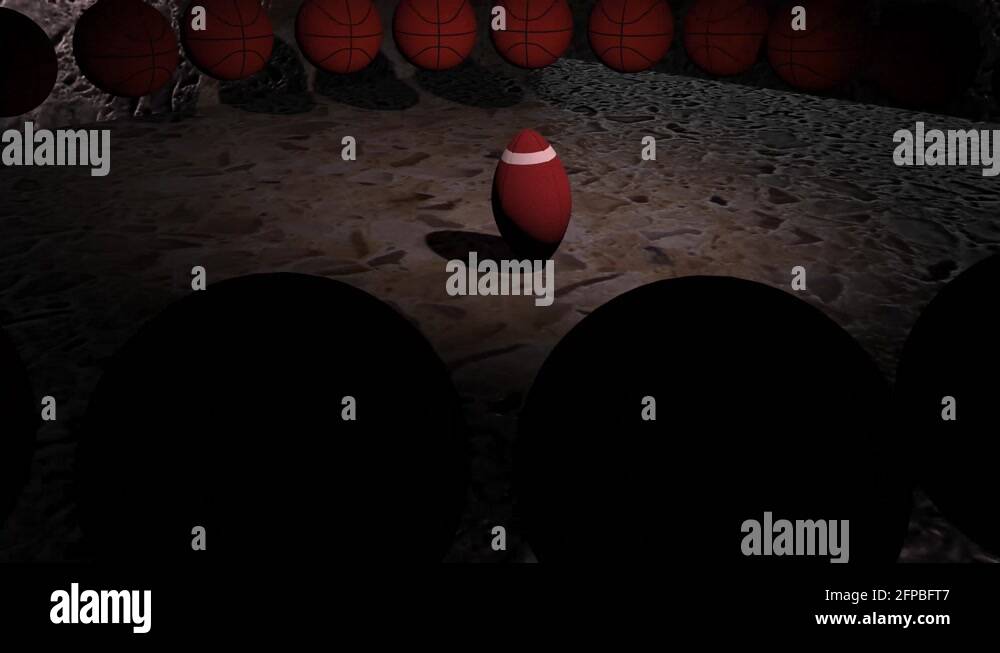 A group of basket balls surrounding a foot ball in a back alley Stock ...