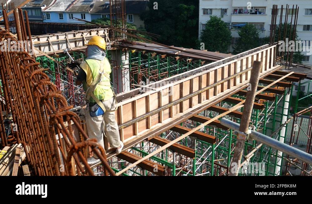 Construction workers installing & fabricating timber formwork and Stock ...