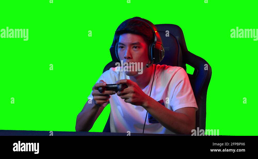 Pro esport gamer playing in online video game over green screen ...