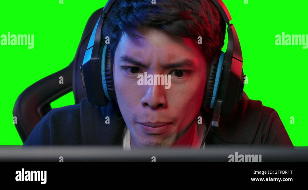 Pro gamer playing online video game over green screen background Stock ...