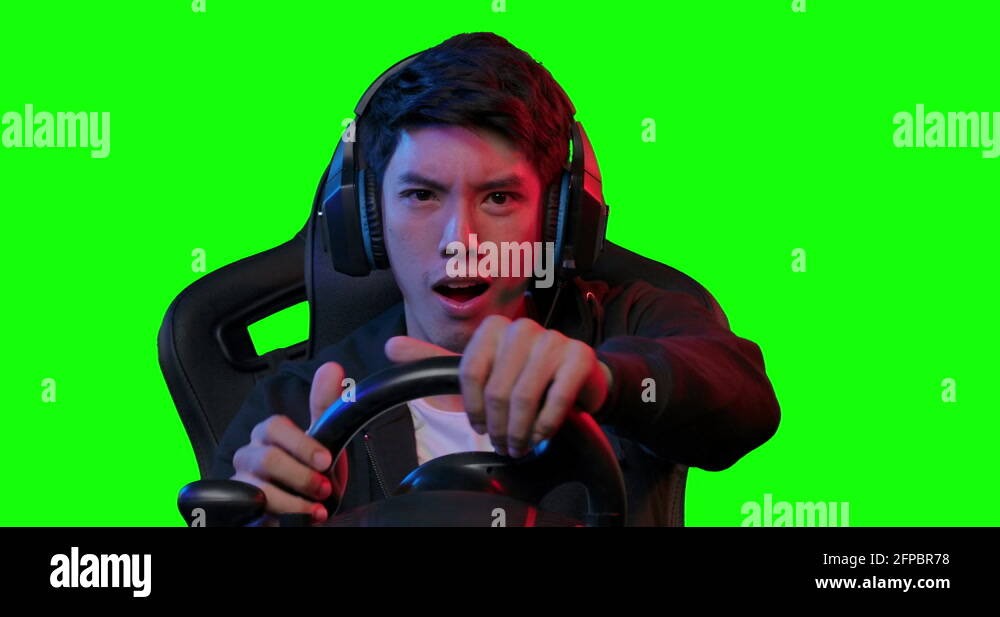 Pro gamer playing in car racing game over green screen background Stock ...